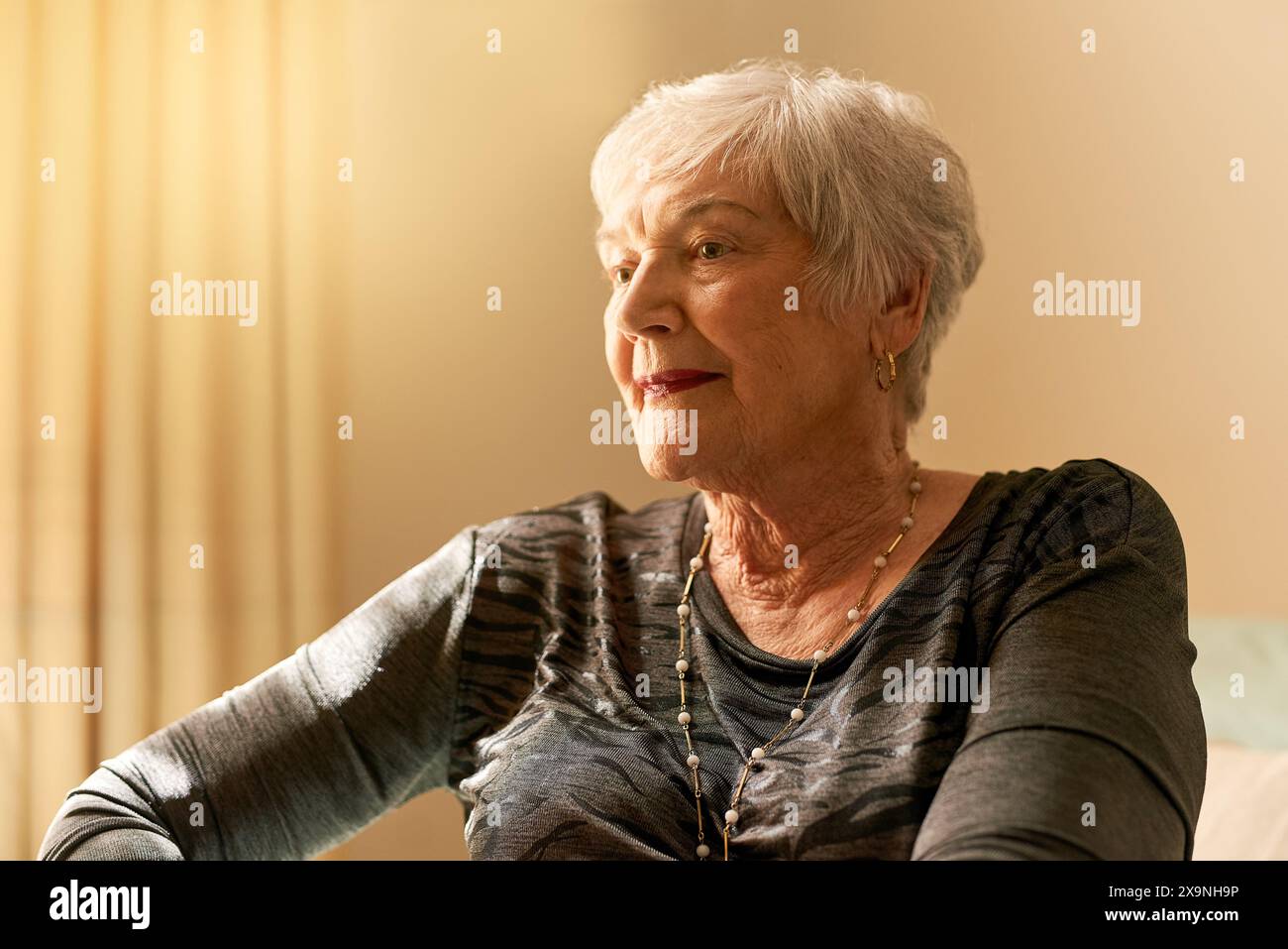 Elderly woman, sad and thinking in home for retirement with depression ...