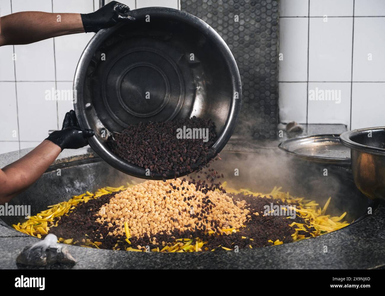 Male cook pours chickpeas hi-res stock photography and images - Alamy