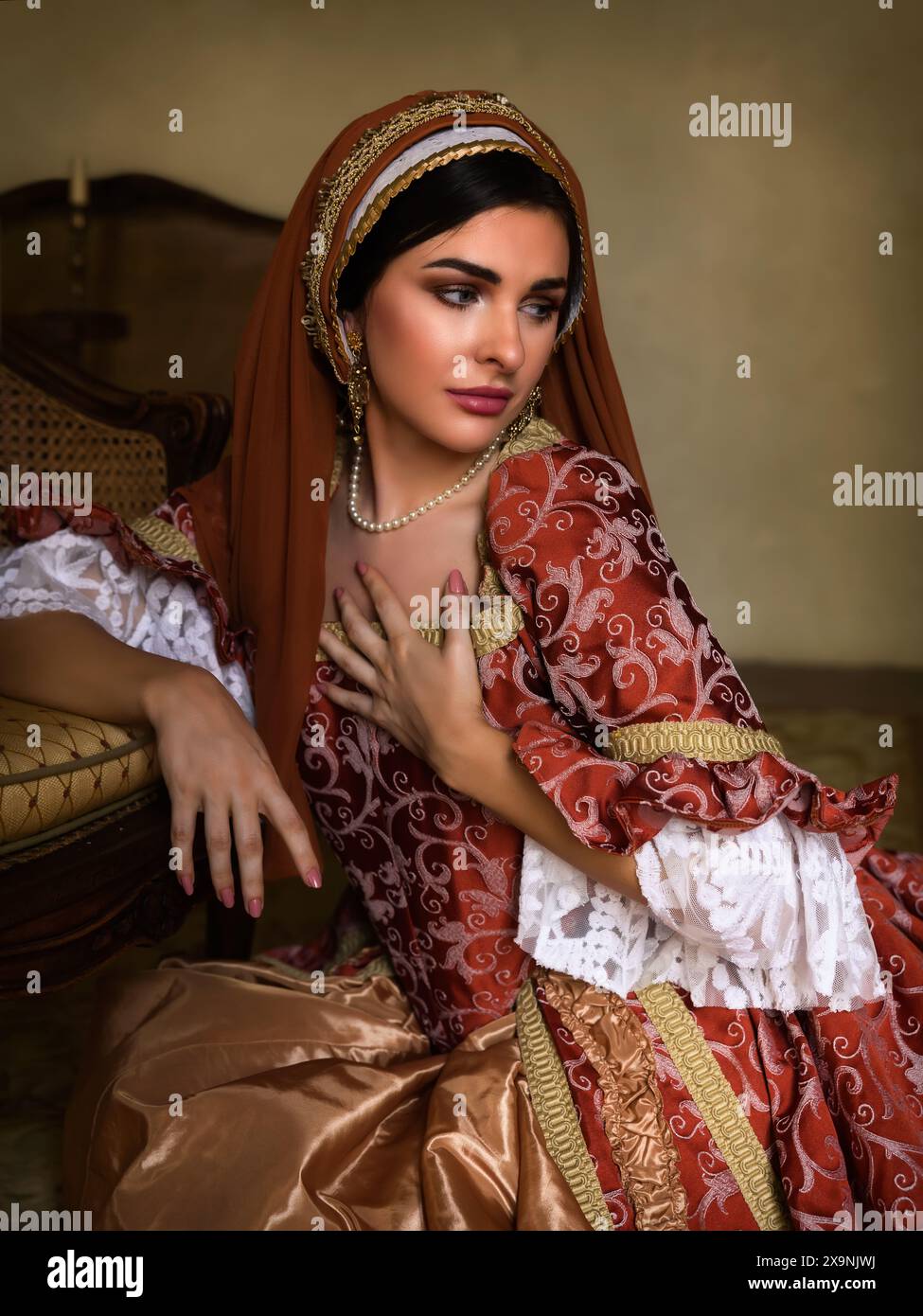 Young woman in medieval renaissance costume and French hood sitting on ...