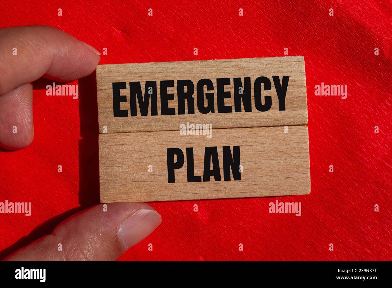 Emergency plan words written on wooden blocks with red background ...