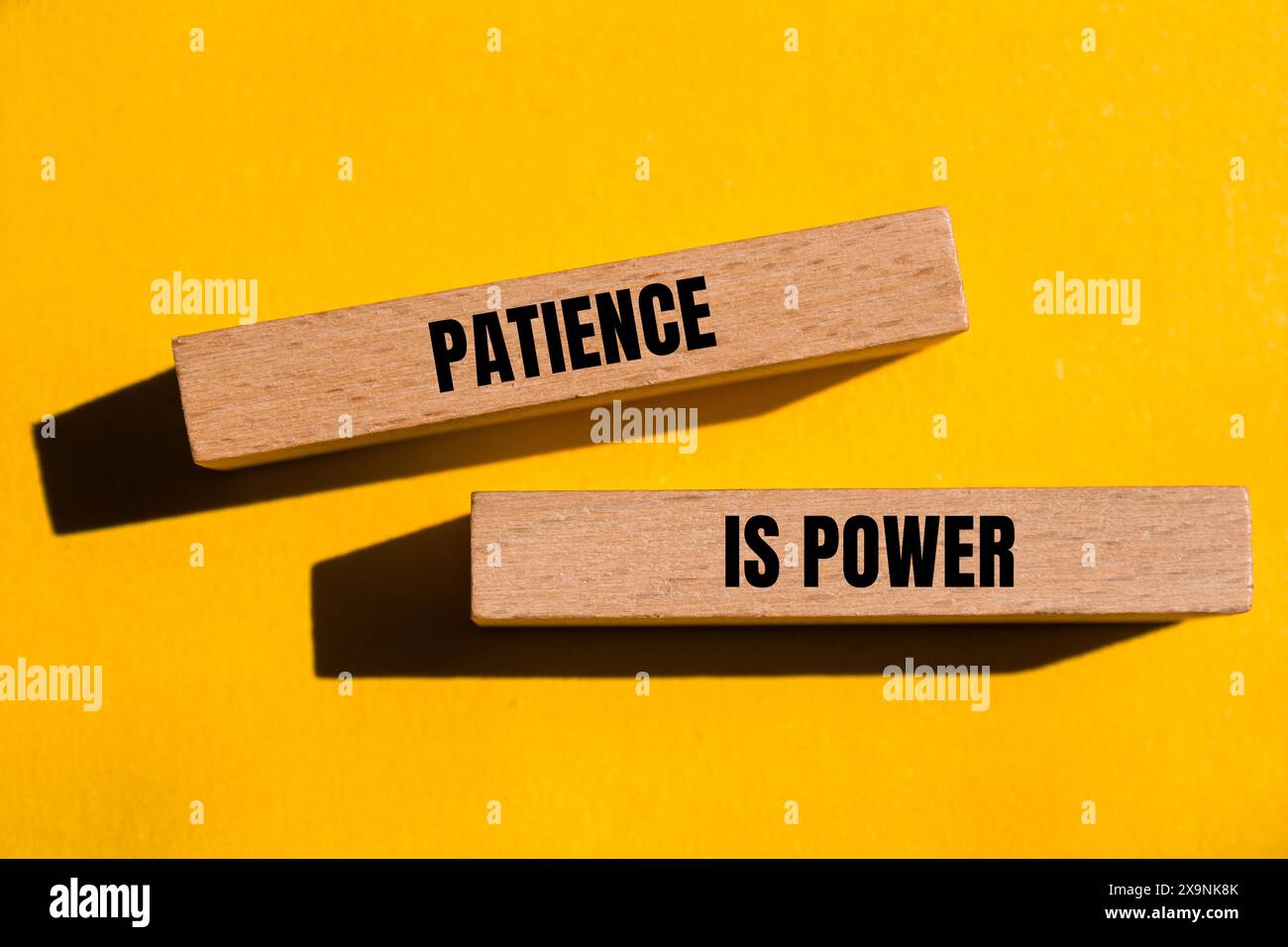 Patience is power words written on wooden blocks with yellow background ...