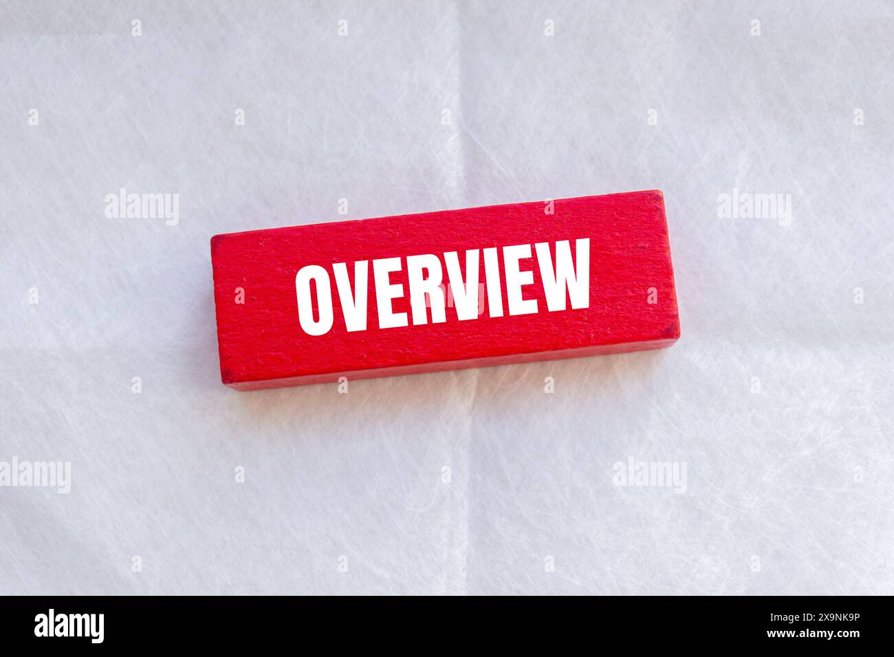 Overview word written on red wodoen block with white background ...