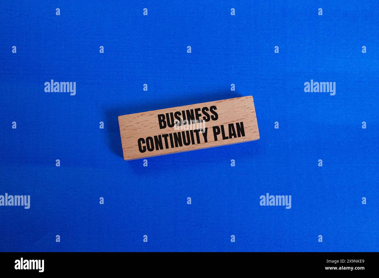 Business continuity plan message written on wooden block with blue ...