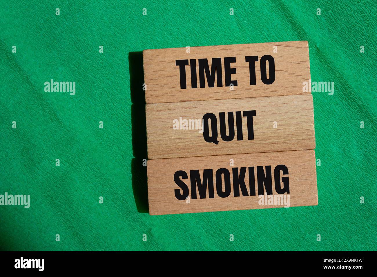 Time to quit smoking words written on wooden blocks with green ...