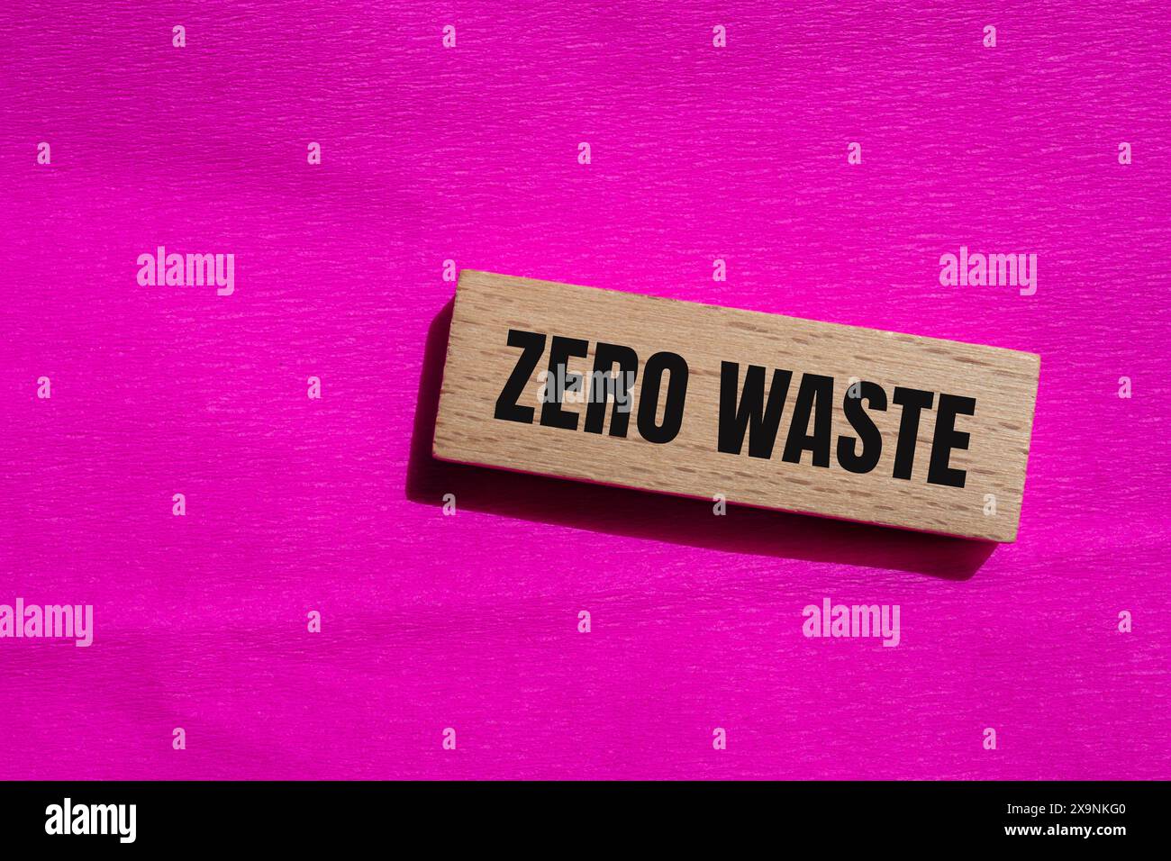 Zero waste words written on wooden block with pink background. Conceptual zero waste symbol ...