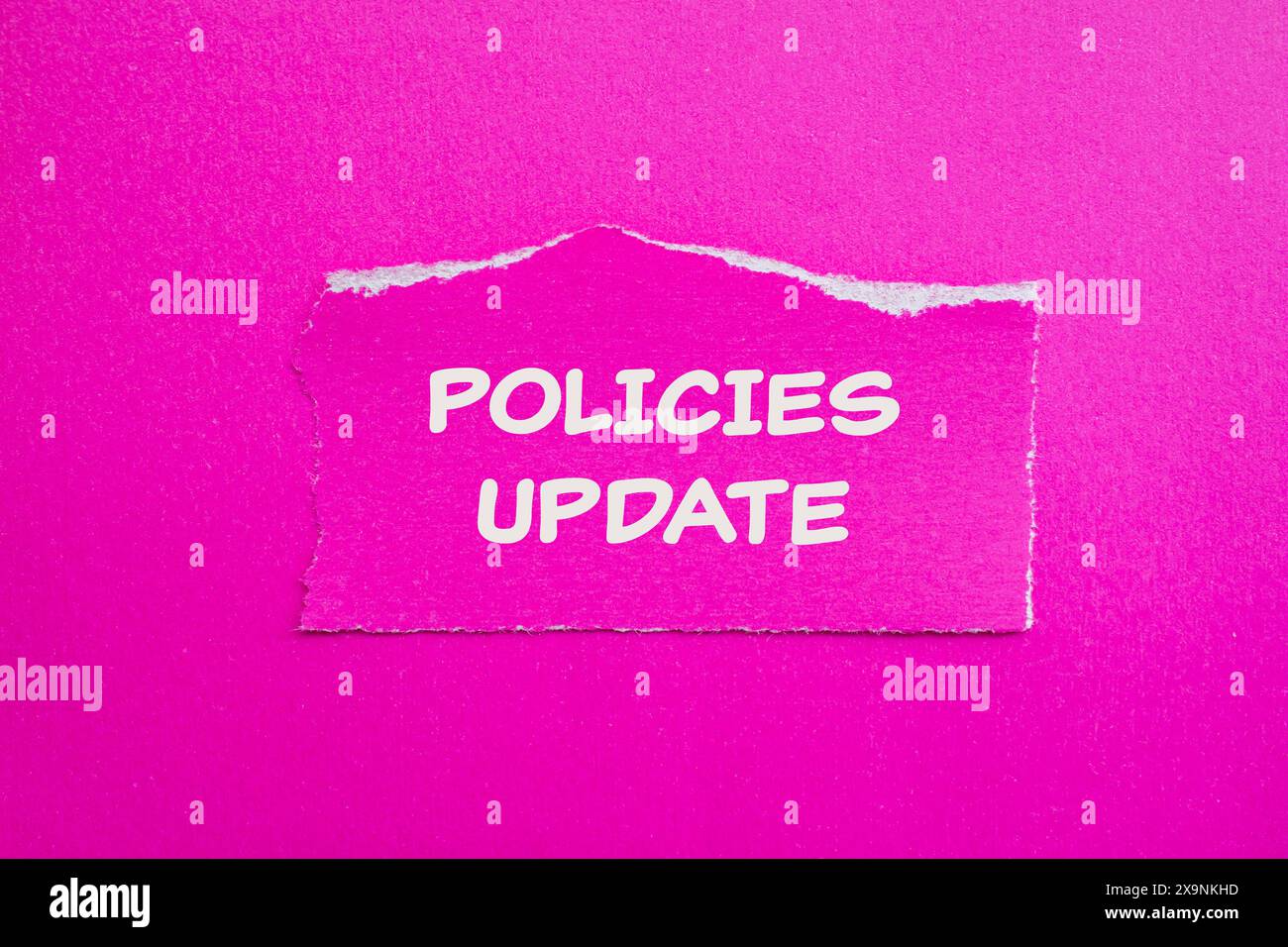 Policies update words written on ripped paper with pink background. Conceptual policies update ...