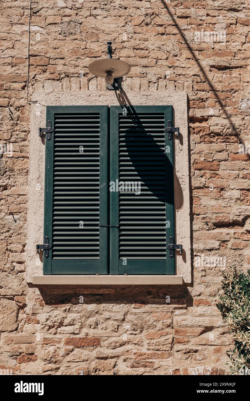 Traditional green painted shutters on a window in the historic medieval ...