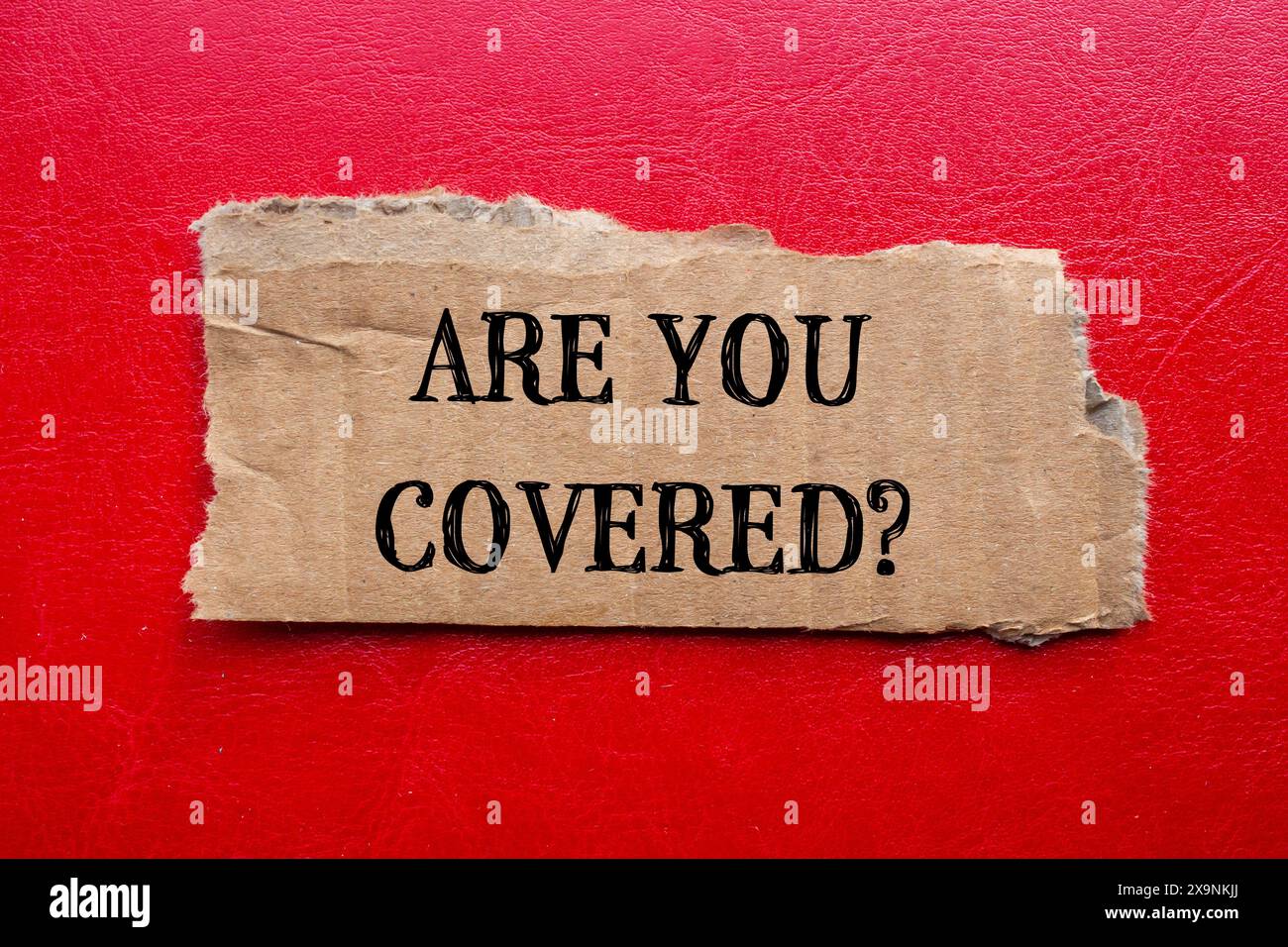 Are you covered ? words written on ripped cardboard paper piece with ...