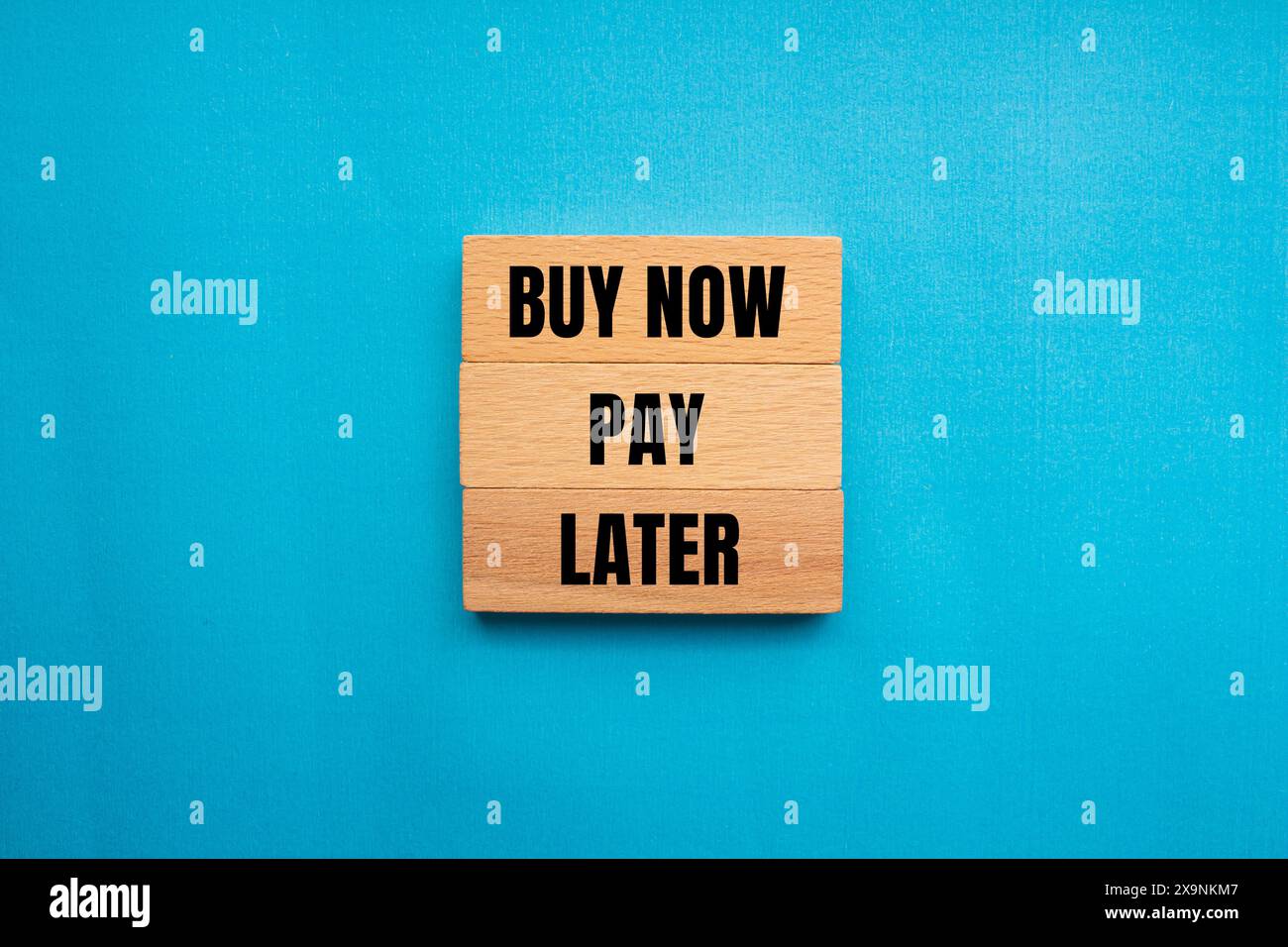 Buy now pay later words written on wooden blocks with blue background ...