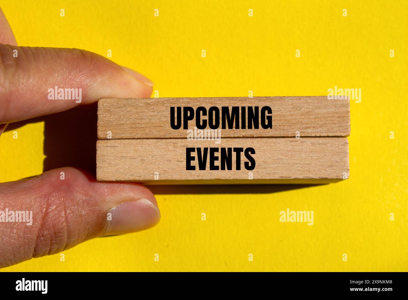 Upcoming events words written on wooden blocks with yellow background ...
