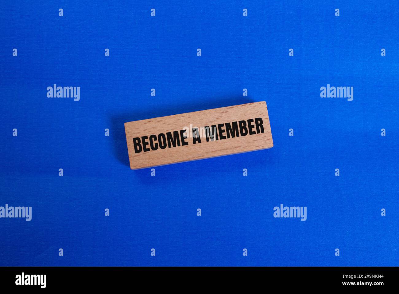 Become a member message written on wooden block with blue background ...