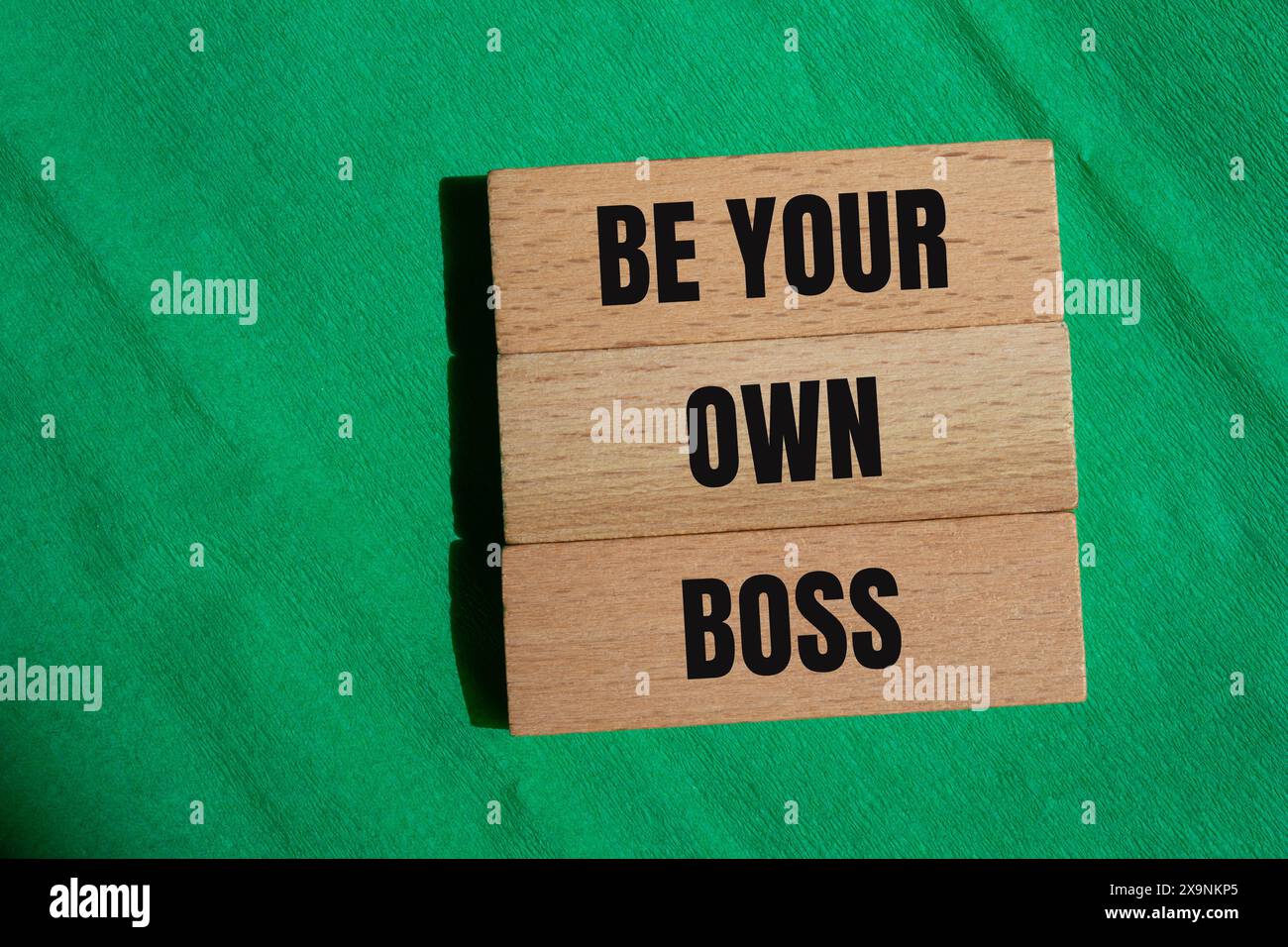 Be your own boss words written on wooden blocks with green background ...