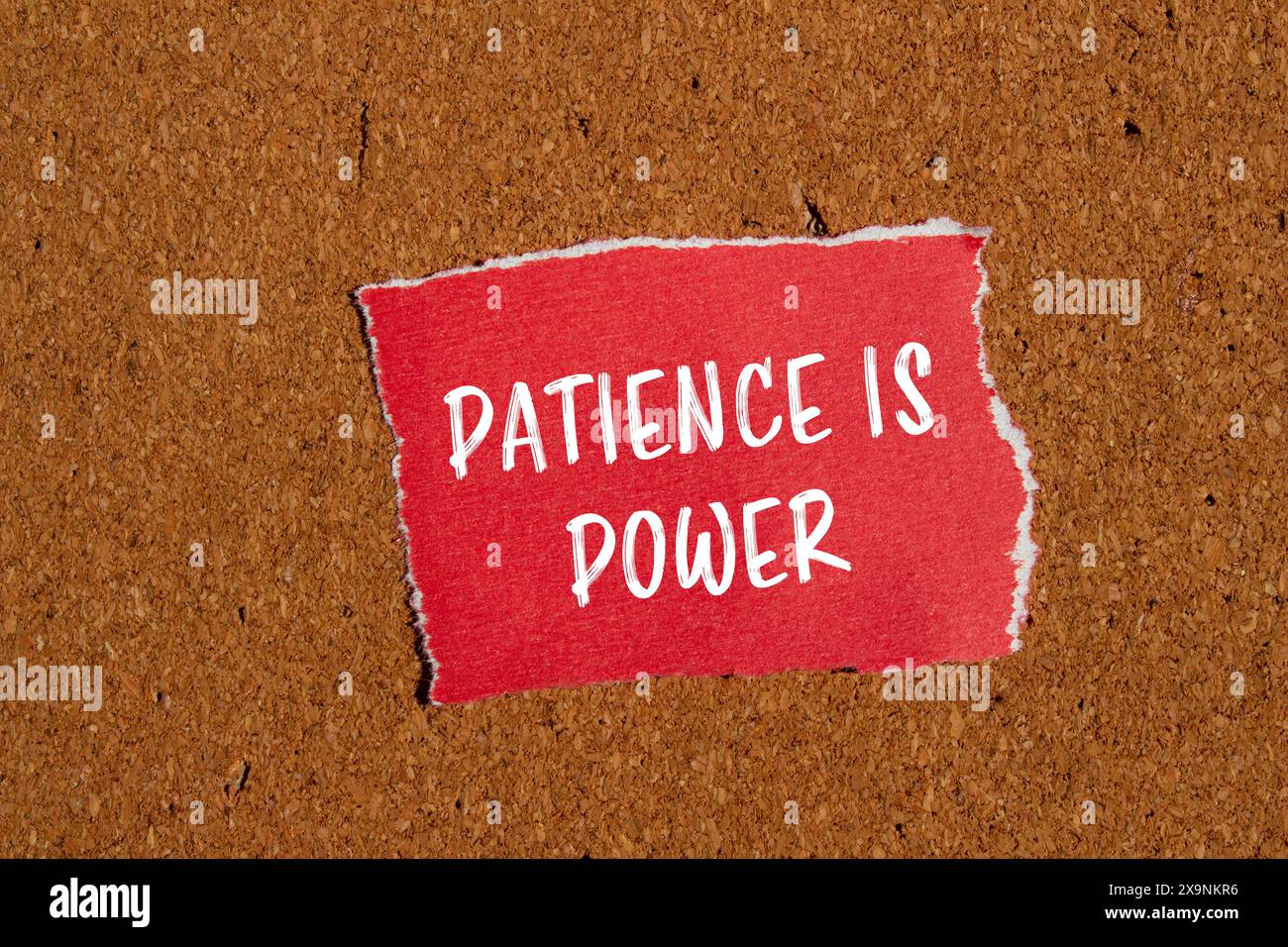 Patience is power words written on ripped red paper piece with brown ...