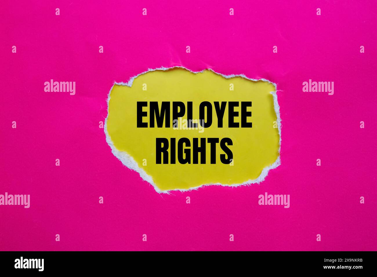 Employee rights words written on ripped pink paper with yellow ...