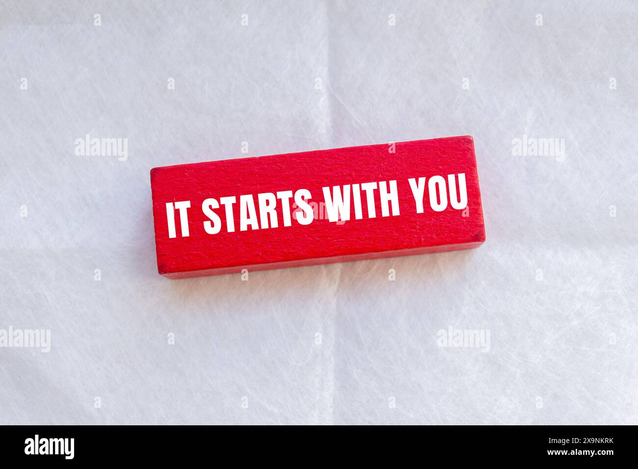 It starts with you words written on red wodoen block with white ...