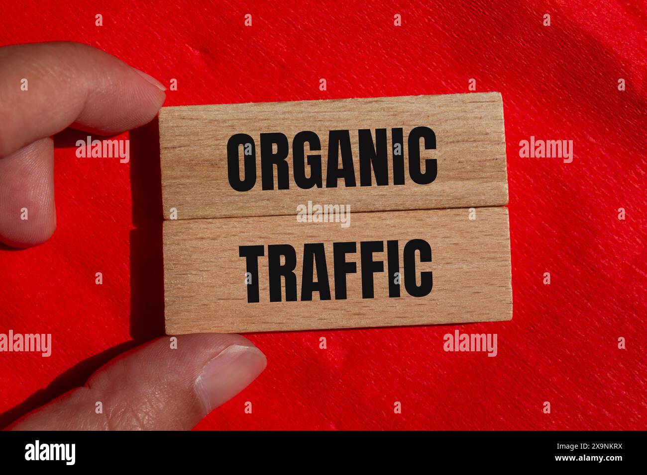 Organic traffic words written on wooden blocks with red background ...