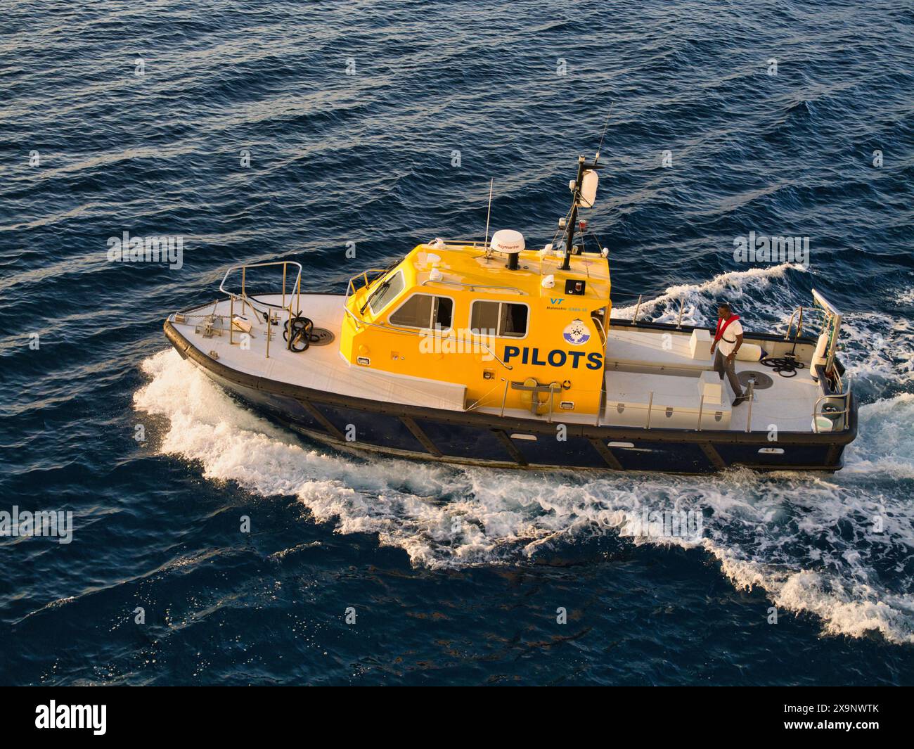 Grenada - Feb 2 2024: Travelling at speed, the yellow pilot boat from ...