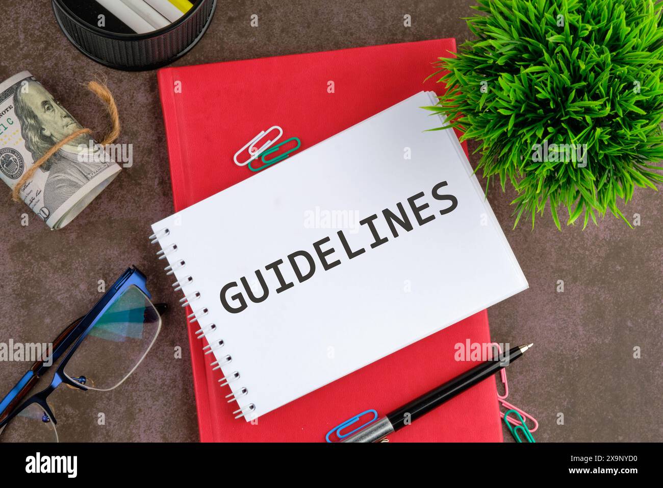 Guidelines concept. Guidelines word written on a blank sheet of notepad ...