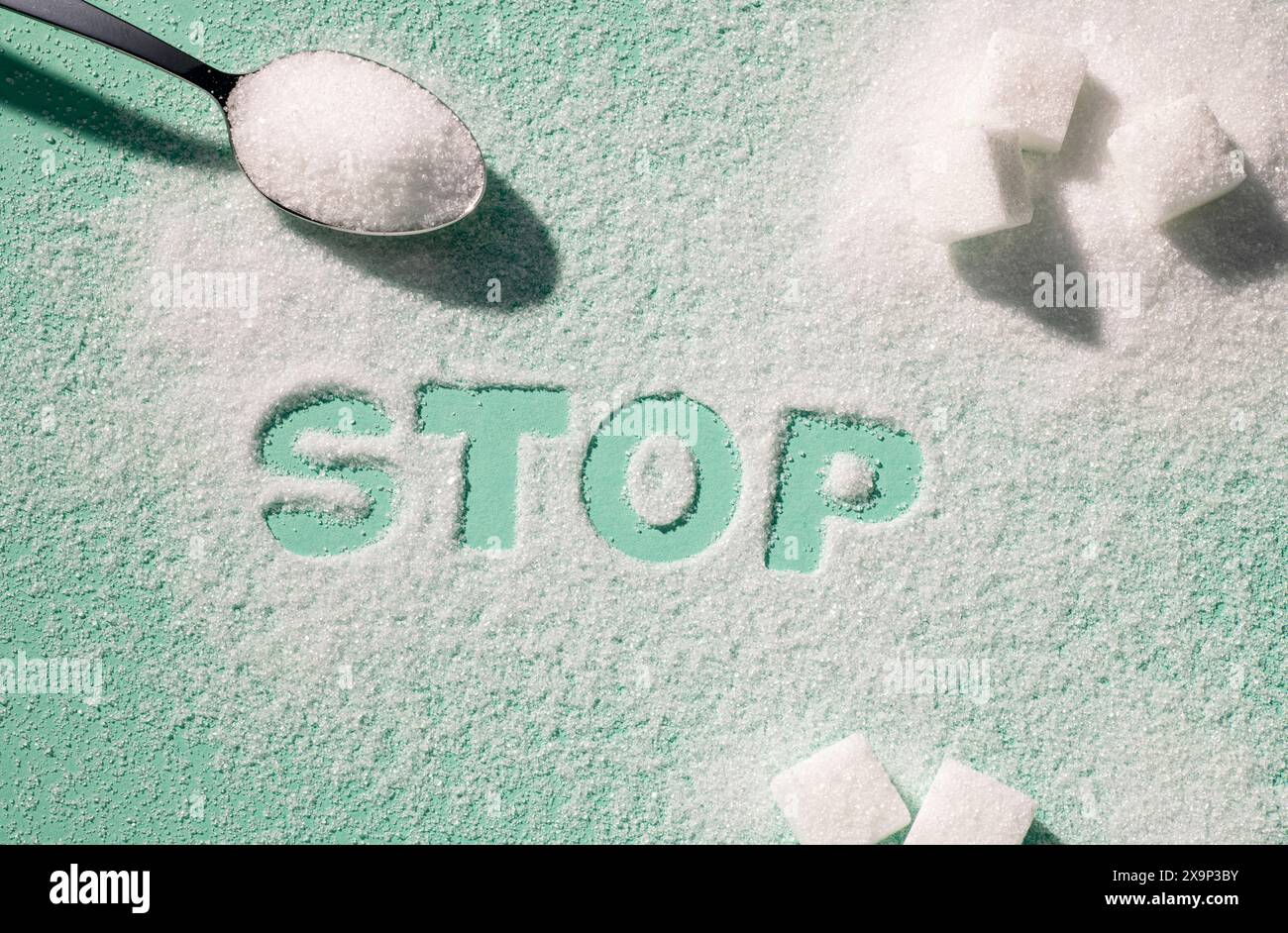 The German word Stop written with sugar on a turquoise background Stock ...
