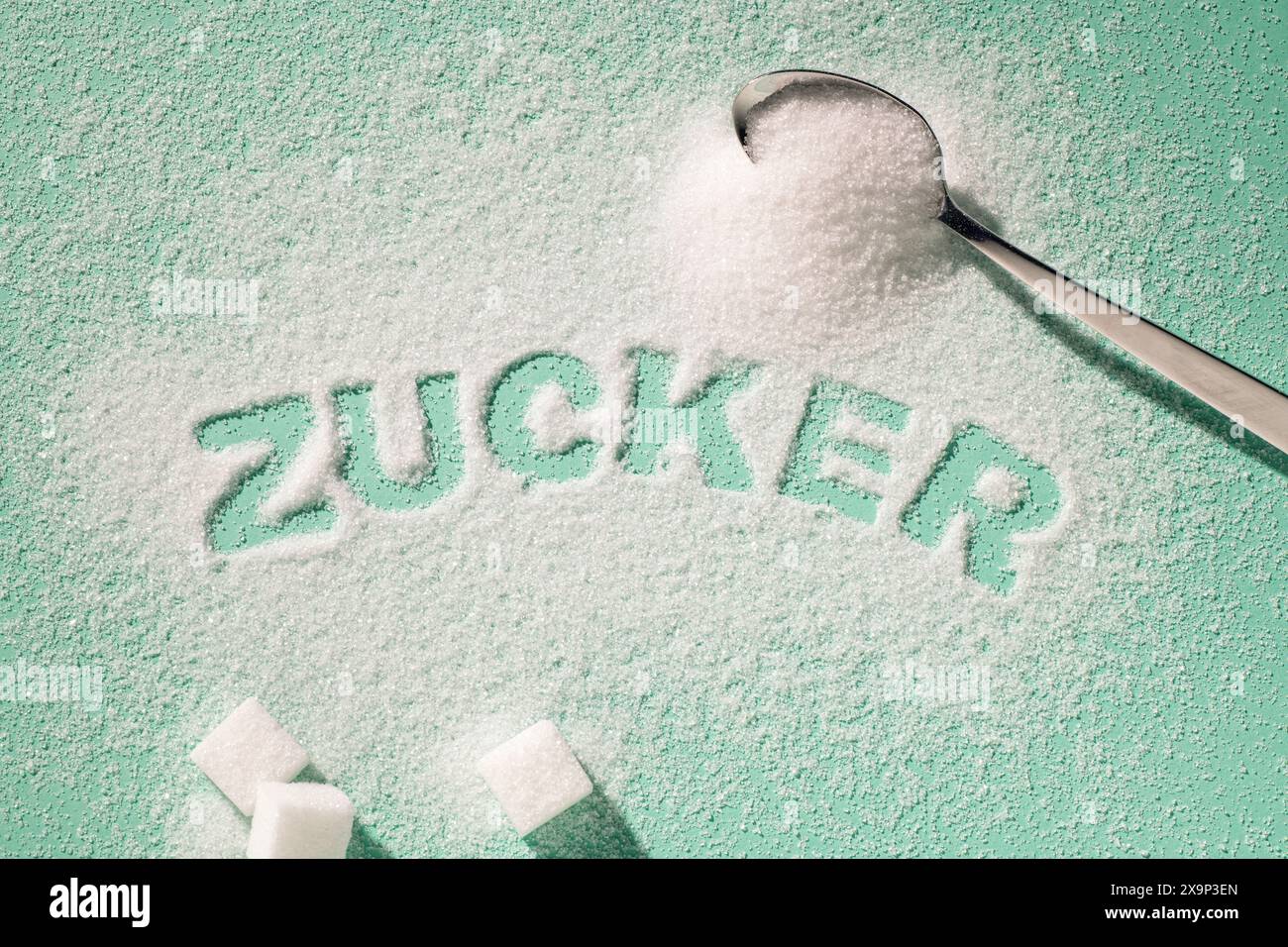 The German word Zucker written with sugar on a turquoise background ...