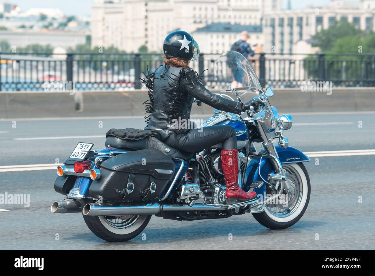 Moscow, Russia - May 26, 2024: A middle-aged female biker proudly leads ...