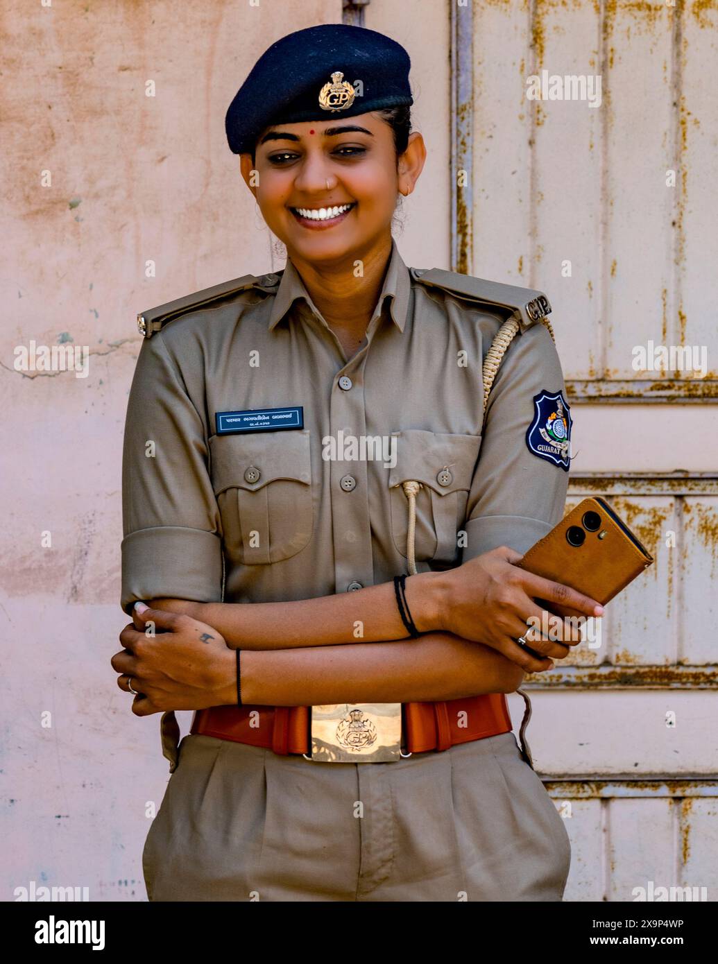 Proud and cheerful female police officer in formal attire poses ...