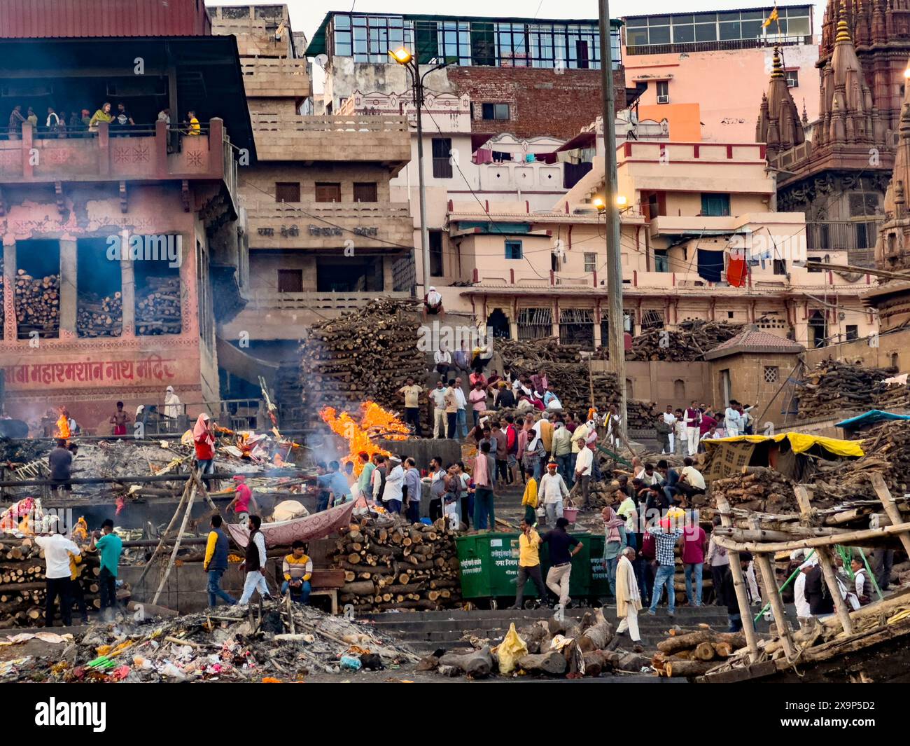 Busy scene at the sacred cremation ghats of varanasi, with traditional ...