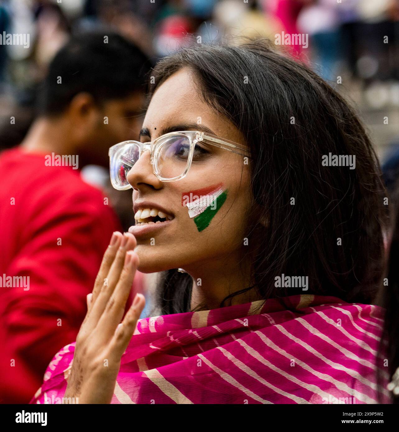 Young woman with flag face paint actively supporting at a public ...