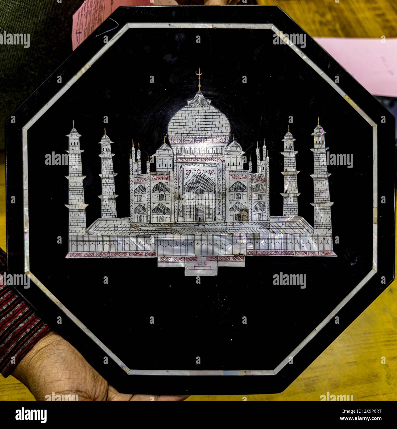 Artisan showcasing a beautiful black octagonal plate with intricate taj ...