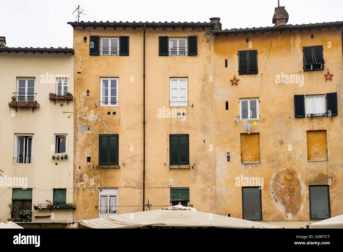 Lucca, Italy - Building facade of Piazza dell Anfiteatro, the heart of ...
