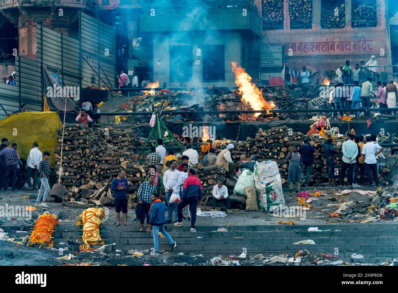 Group of people attending a solemn outdoor cremation ritual by the ...