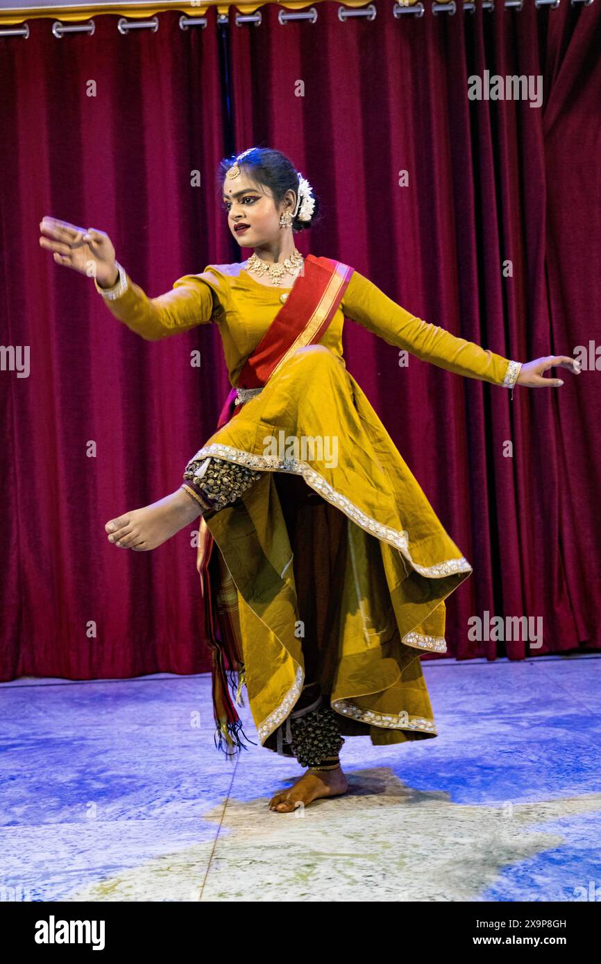 Indian dancer performs a classical dance in vibrant attire on stage ...
