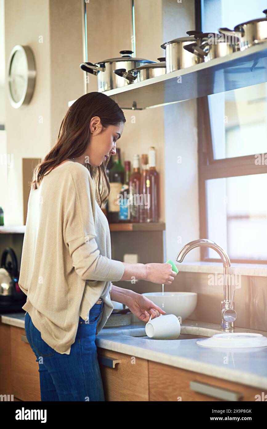 Cleaning, woman and dishes in kitchen for hygiene, routine and coffee ...