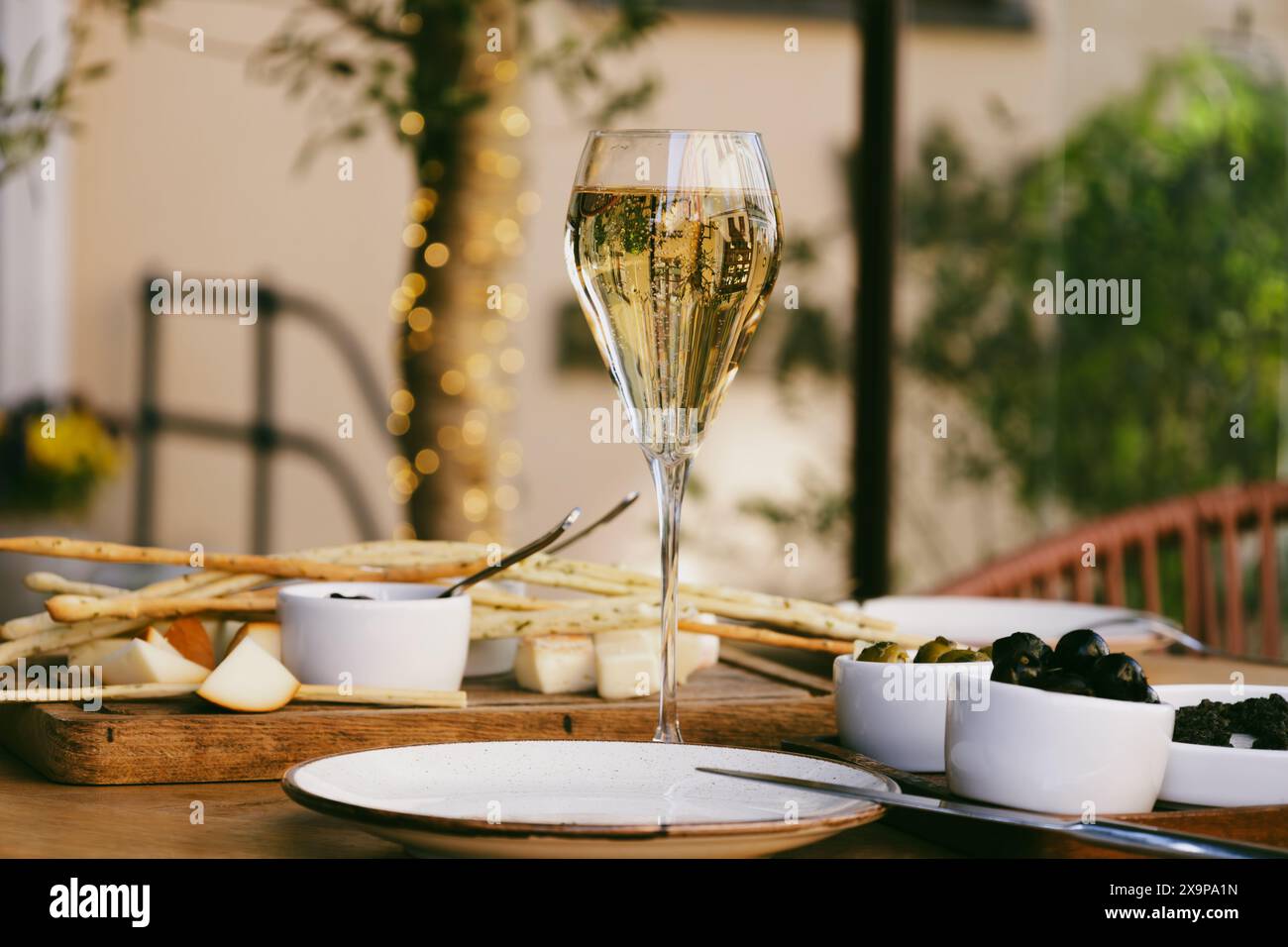 Elegant tall flute of chilled sparkling champagne with different snacks ...