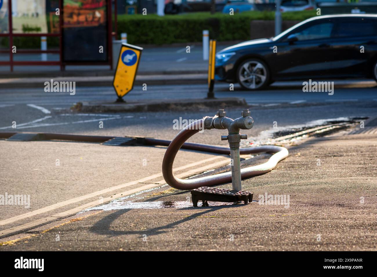 A well in a street has been opened and a fire hydrant connection point ...