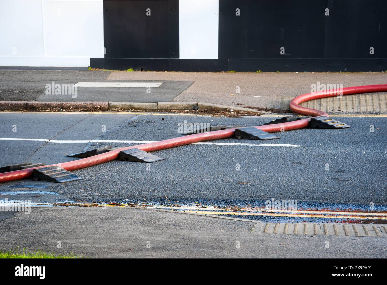 Fire hydrant hose pipe to supply water on road in england uk Stock ...