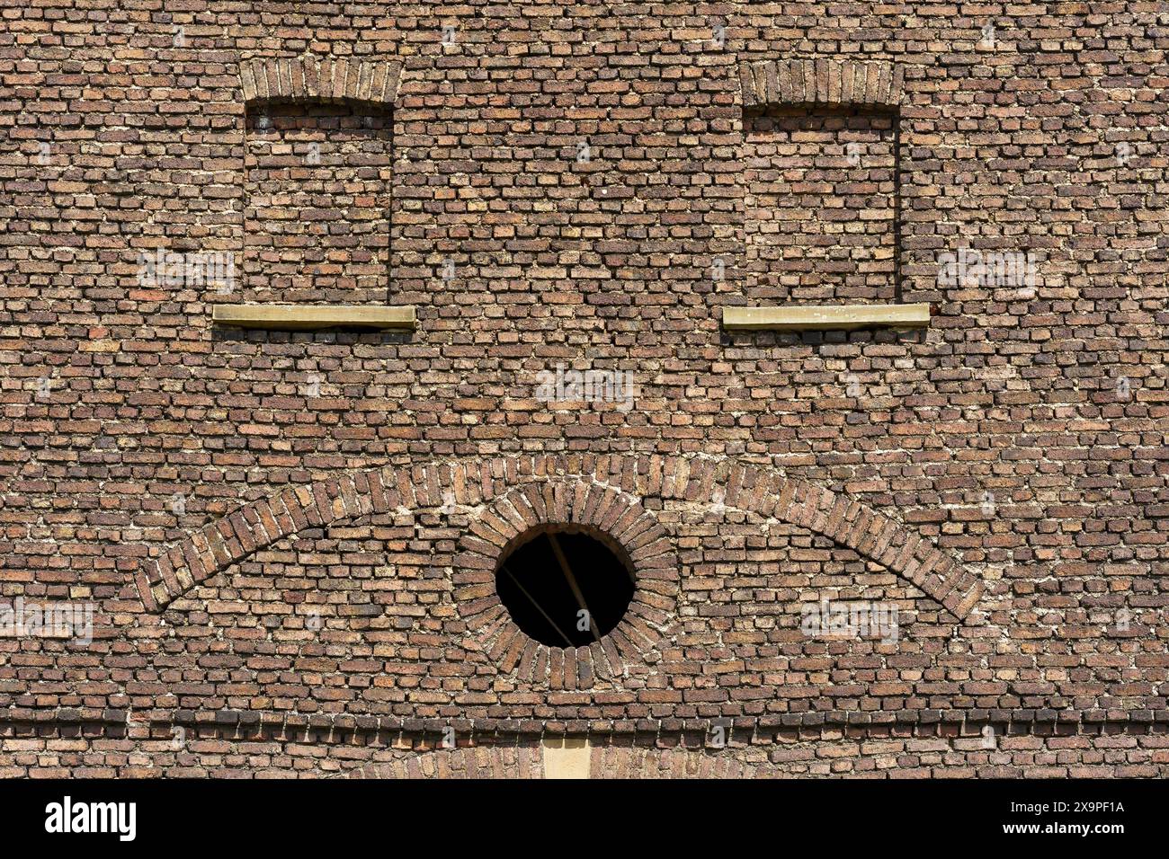 Old brick wall with round window, detail of an ancient building Stock ...