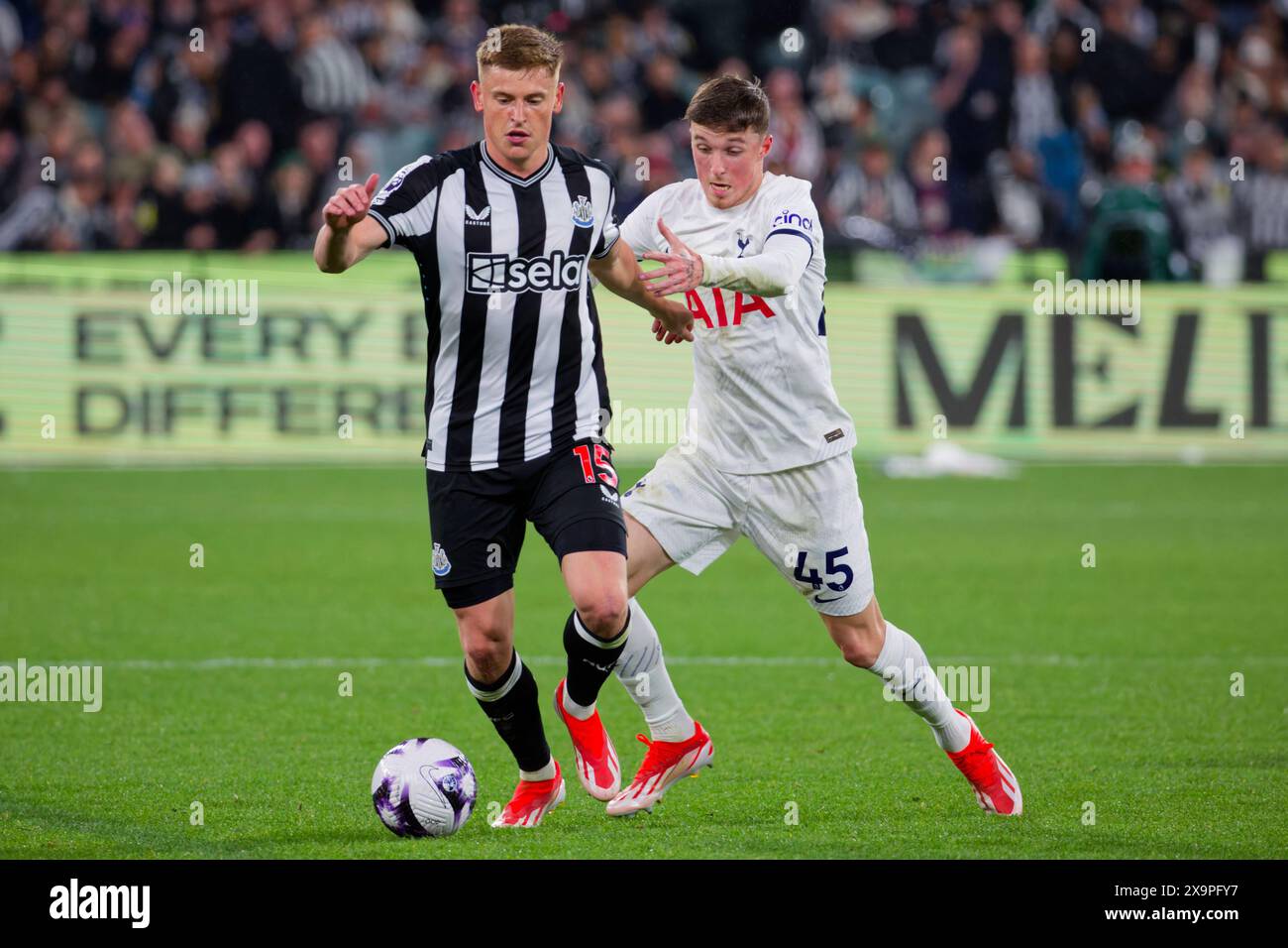 Alfie Devine of Tottenham competes for the ball with Harvey Barnes of ...