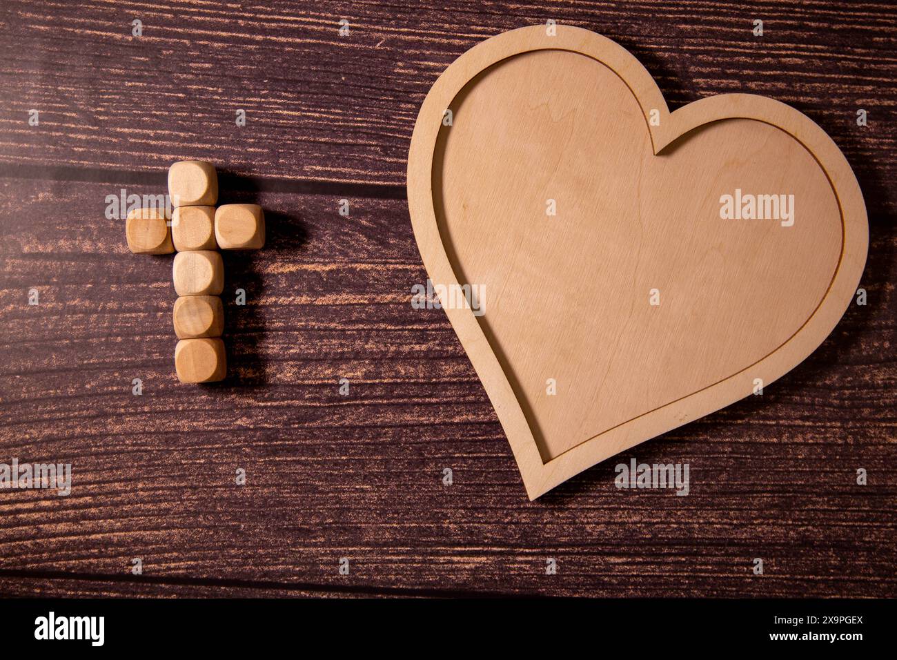 Wooden background with olive heart and white cross for an obituary ... Wooden background with olive heart and white cross for an obituary ...
