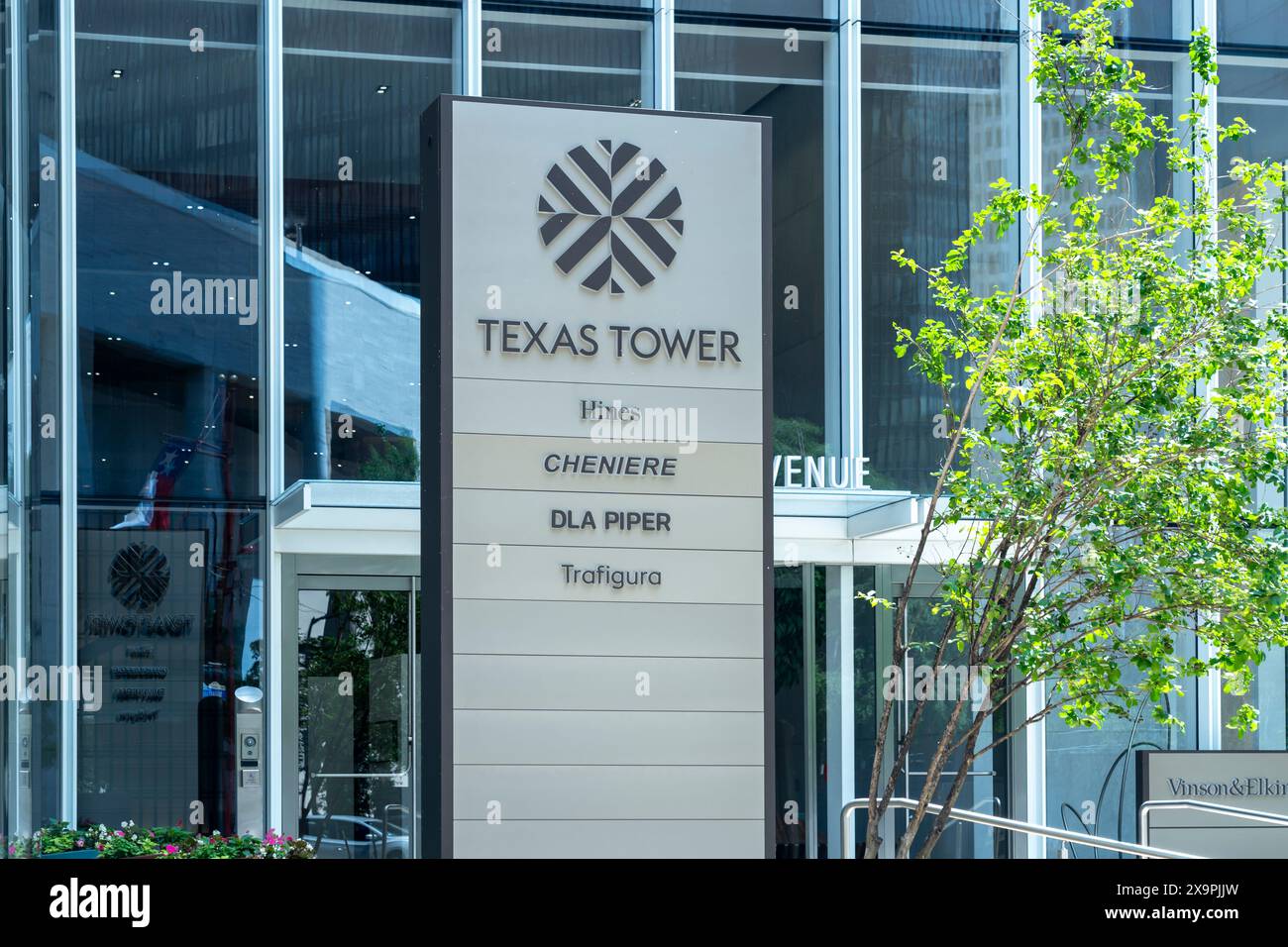 A directory sign at Texas Tower with company name Hines, ChENIERE, DLA ...