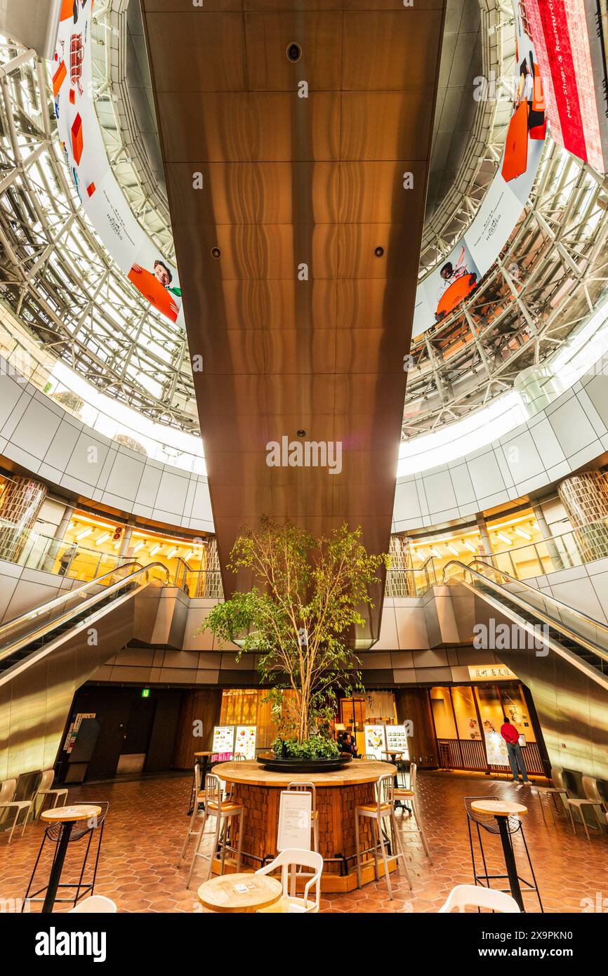 Coffee shop seating area under the escalators connecting the metro with ...