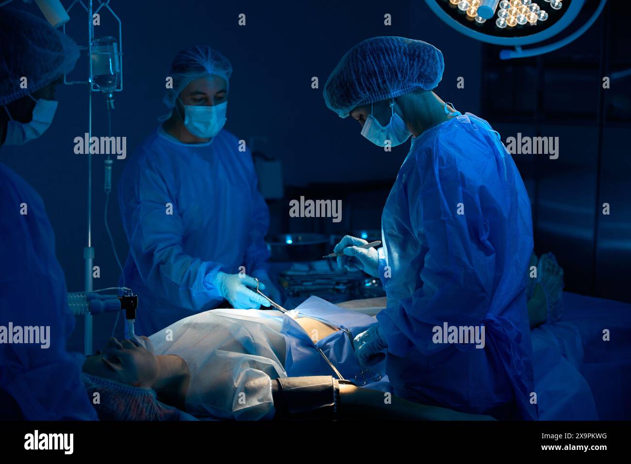 Medical team doing critical operation to female patient saving life ...