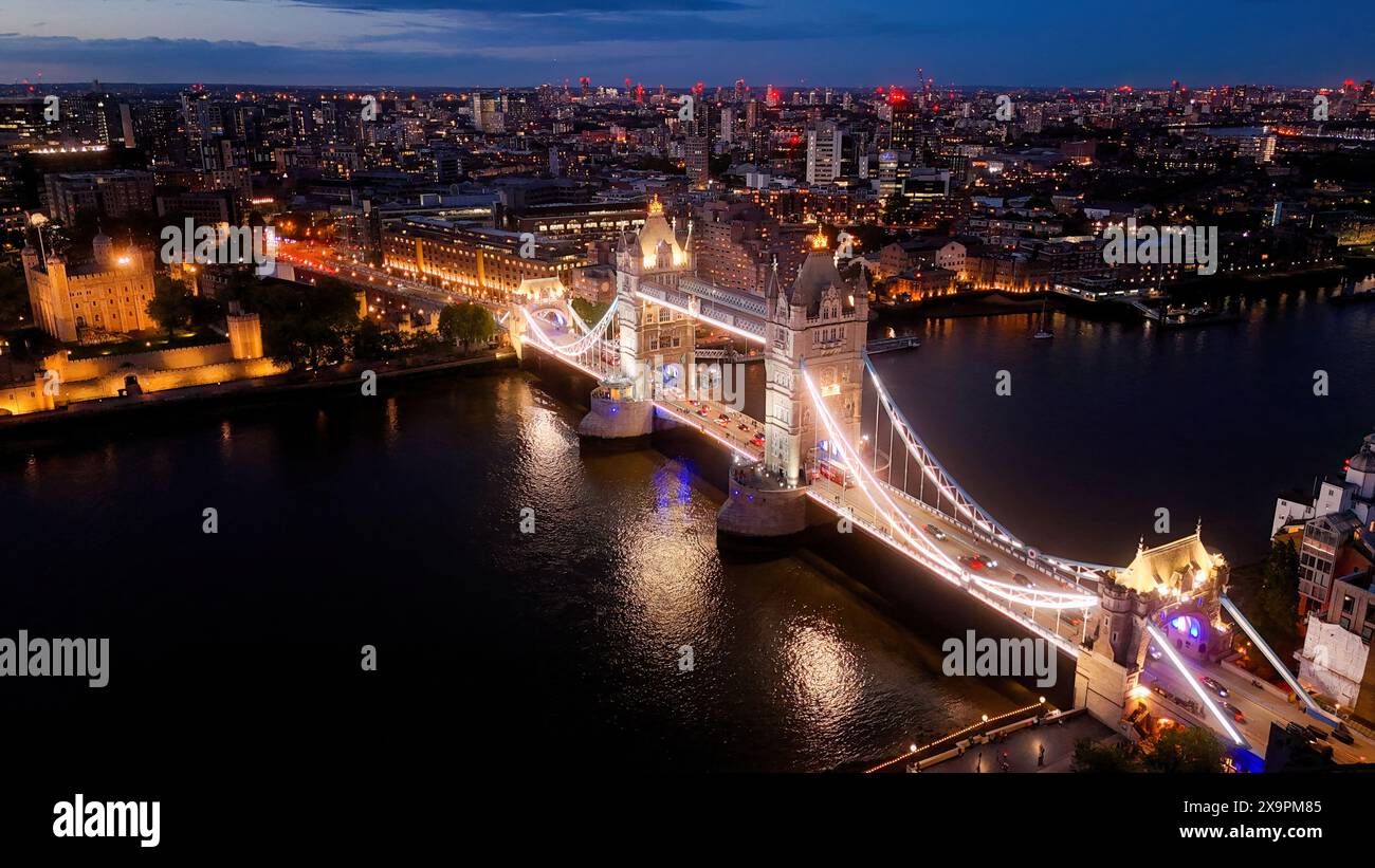 London Tower Bridge illuminated at night - aerial view - UK drone ...