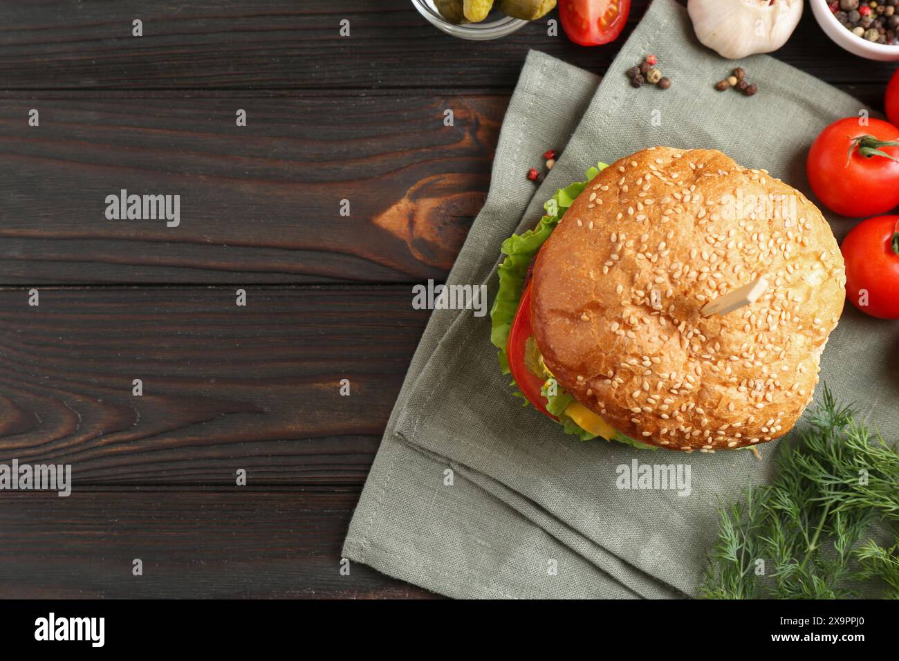 Delicious vegetarian burger and ingredients on wooden table, top view ...