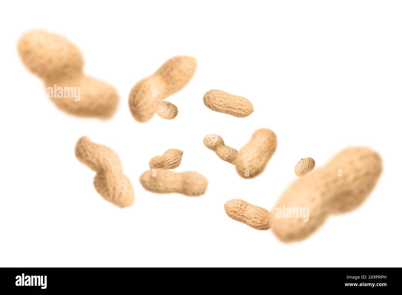 Unpeeled peanuts in air on white background Stock Photo - Alamy