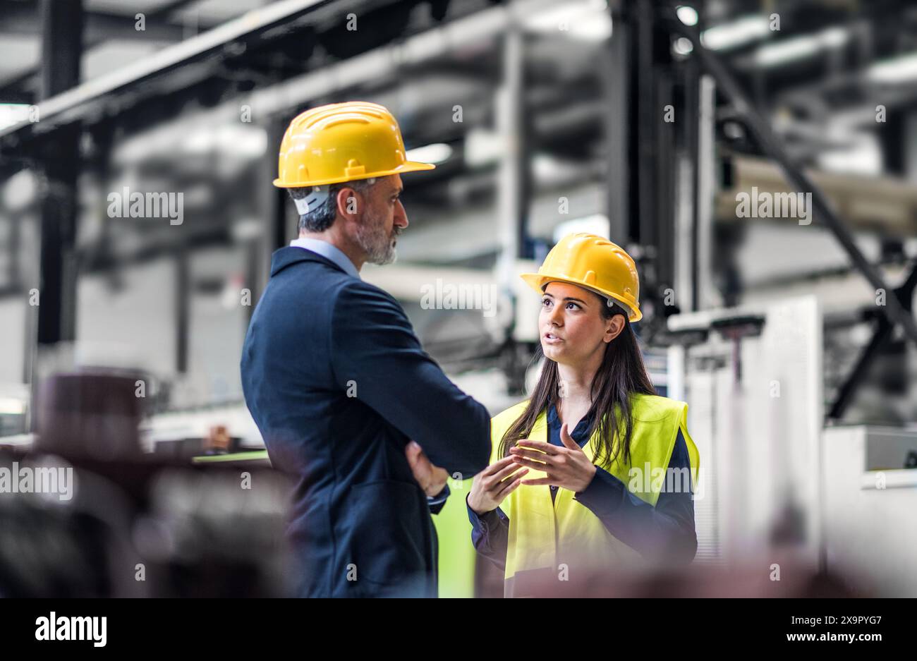 Warehouse worker talking with logistics employee in warehouse, planning ...