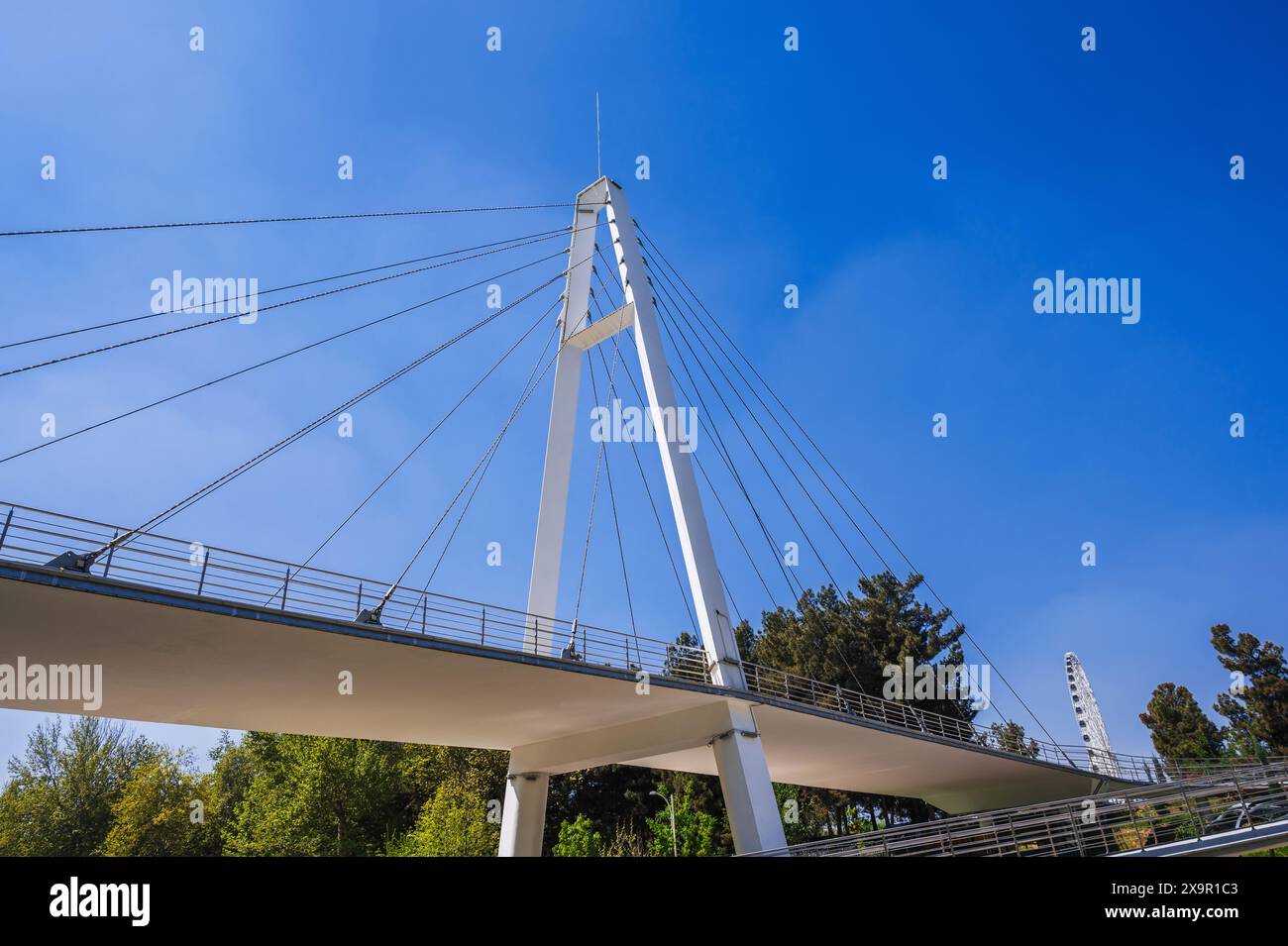 construction of a modern cable-stayed bridge on background of blue sky ...