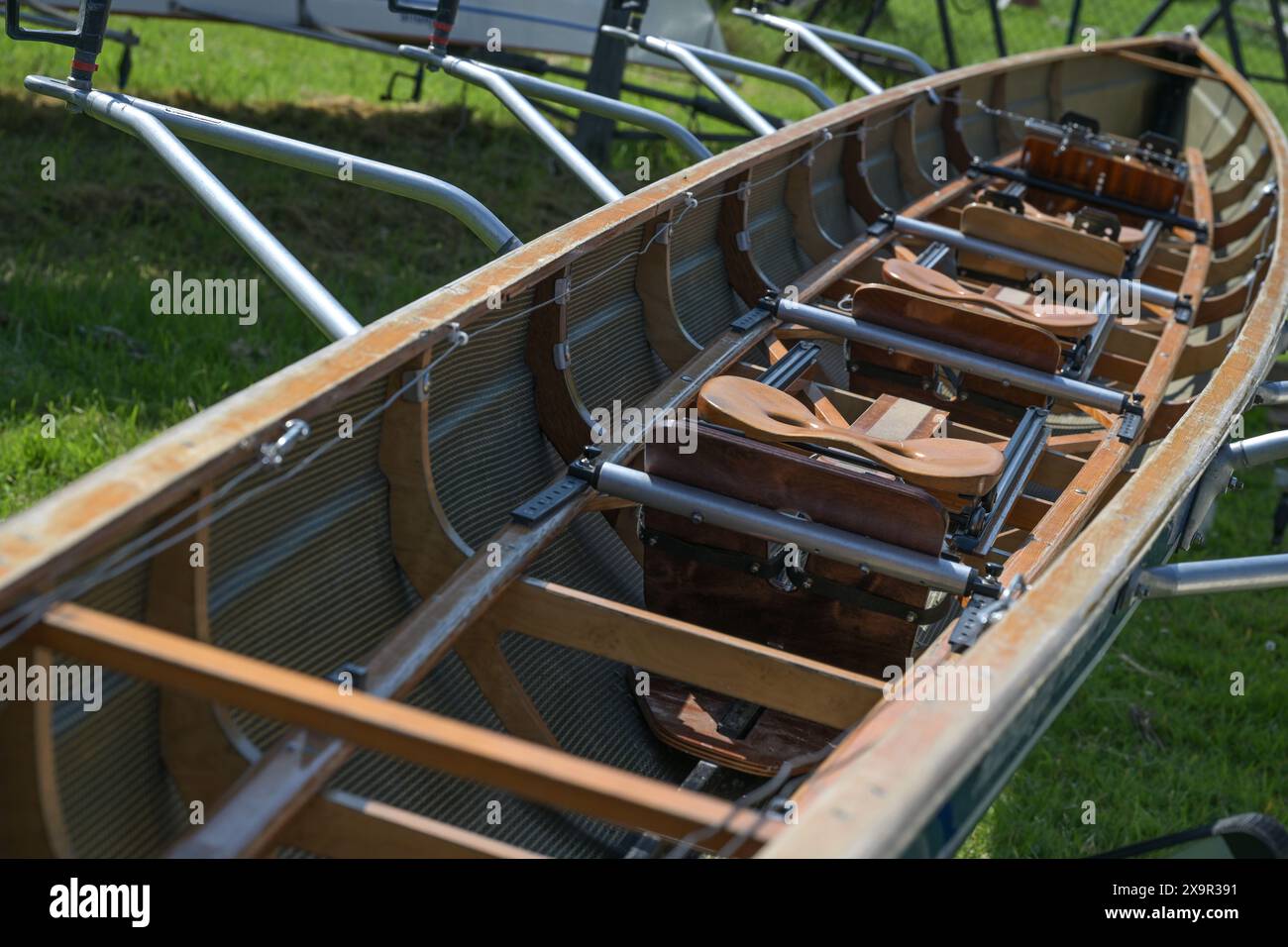 Long wooden sport boat for rowing regatta with sliding seats and ...