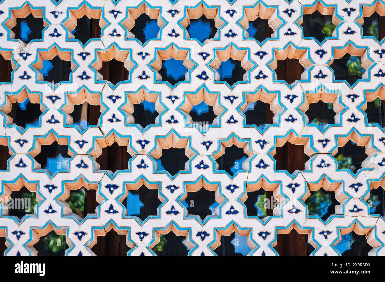 ancient lattice of ceramic tiles with a star pattern on window of the ...