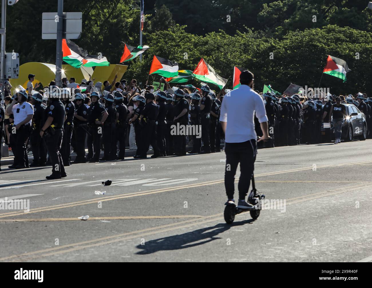 Brooklyn, NY - May 31 2024: Jewish man rides electric scooter in front ...